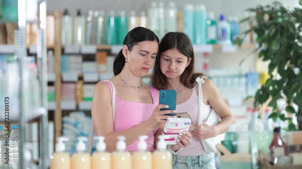 Friendly family of mother and daughter clients choosing box of ...