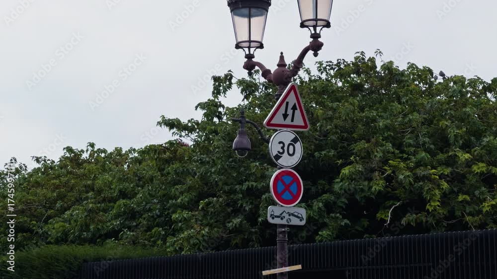 Street Signage that includes Traffic Indicators and a Lamp Post in a ...