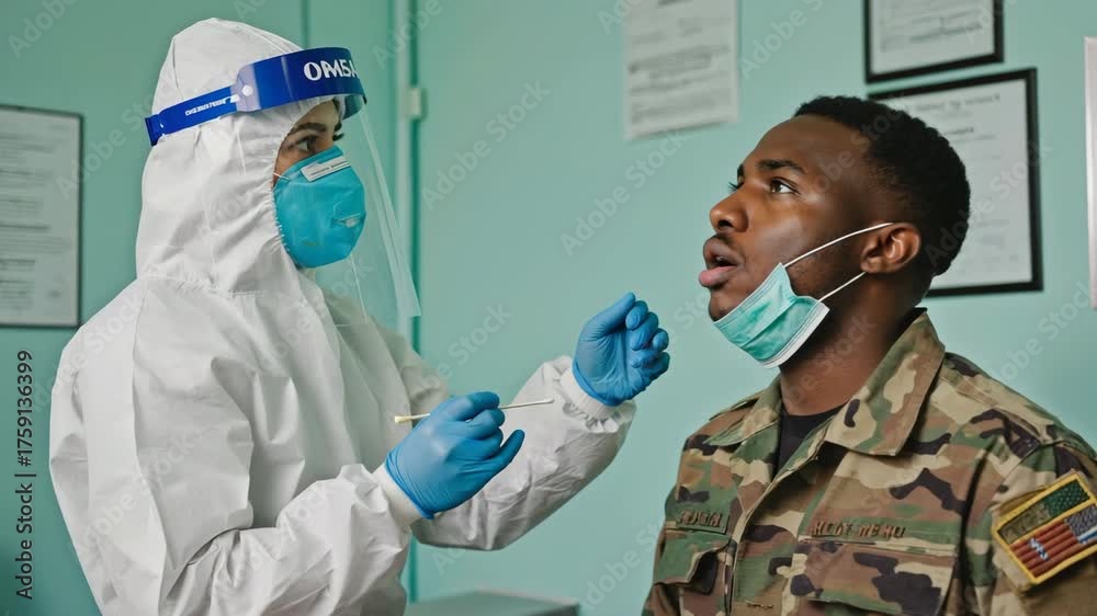 Healthcare workers performing a nasal swab on a male patient in PPE ...