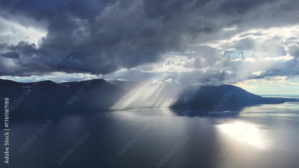 Rain core and slant light meet over the mountain wall by Lake Lama ...