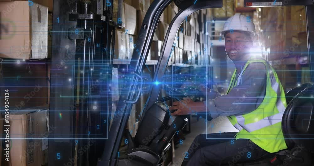 Forklift operator in warehouse checking load and lifting pallet with ...