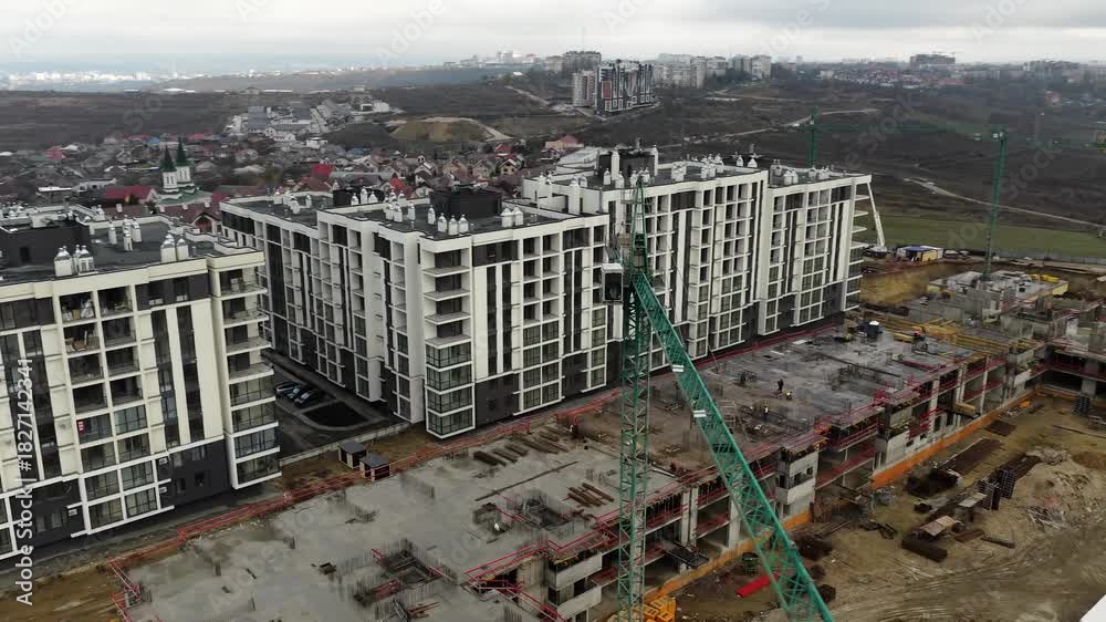 Forward drone movement over construction site with workers installing ...
