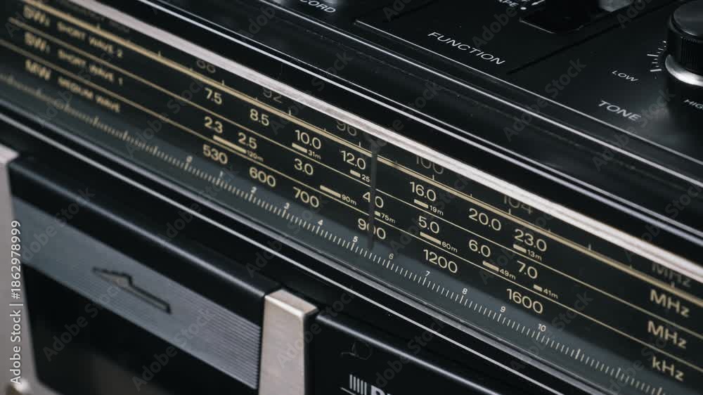 Wide macro shot of a radio tuner indicator scanning across an analog ...