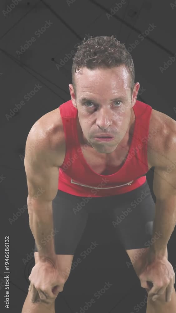 Vertical video: Post-sprint athlete raising head gasping rubbing hair ...