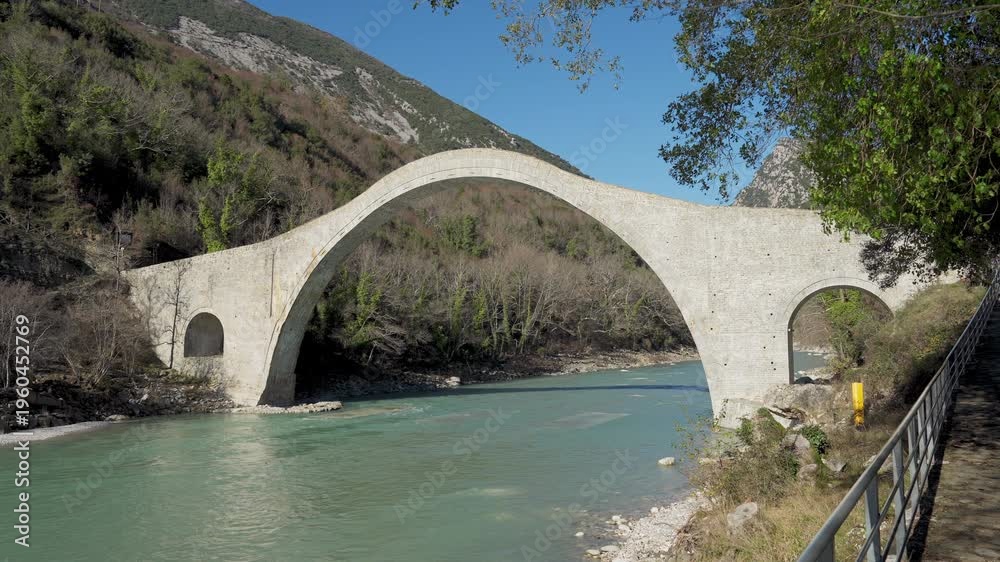 Wide panoramic view of Plaka Bridge, the iconic stone arch bridge in ...