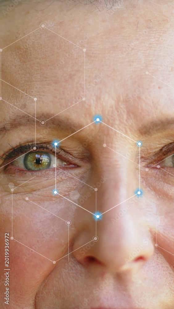 Vertical video: Mature woman opening eyes as blue node on brow forming ...