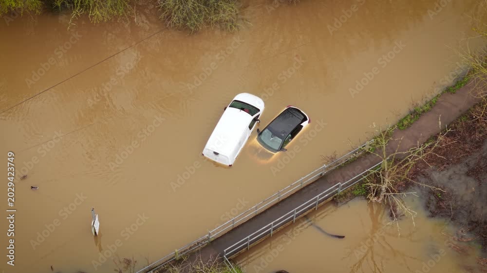 Cars submerged in floodwater during heavy rain season across Britain ...