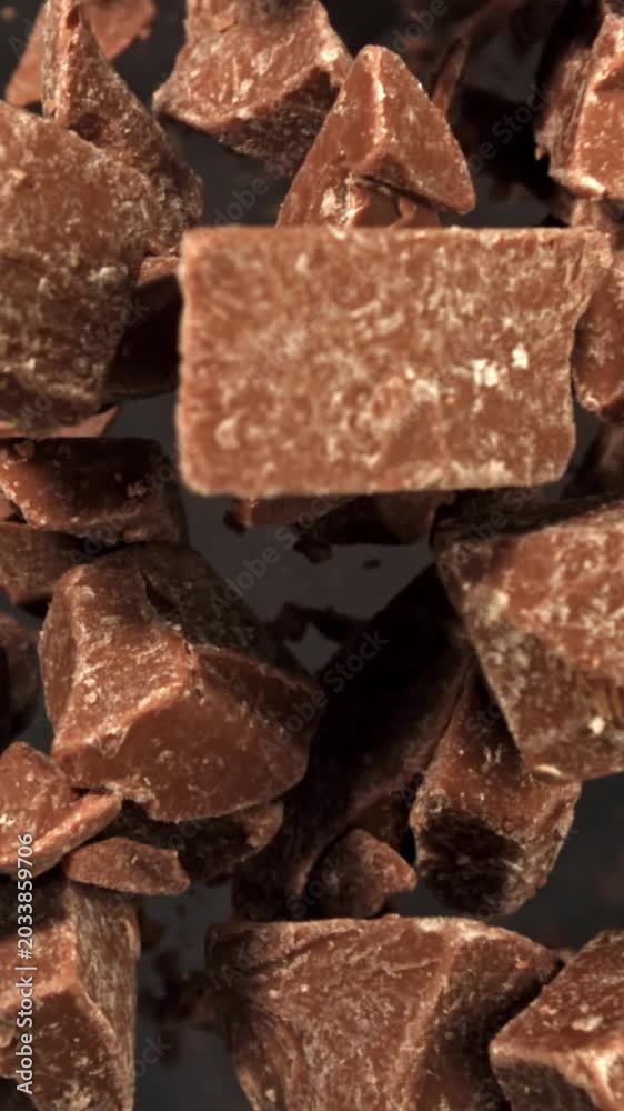 Super slow motion pieces of dark milk chocolate. Filmed on a high-speed ...