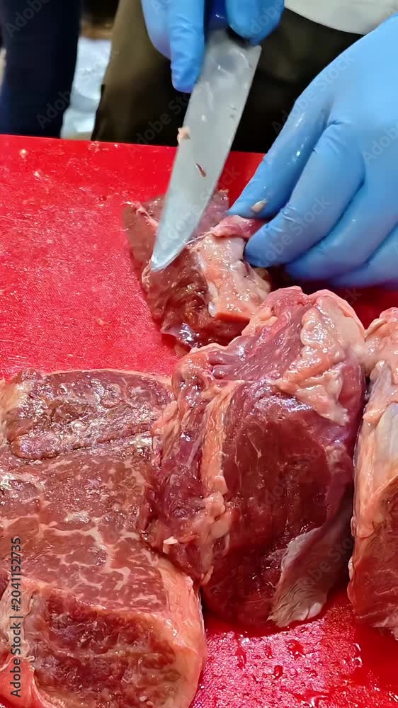 Butcher trimming fat tendon from beef steak piece, Meat Grocery Shop ...