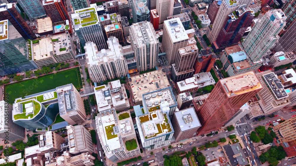 Footage over the tops of modern buildings with green lawns on. Diverse ...