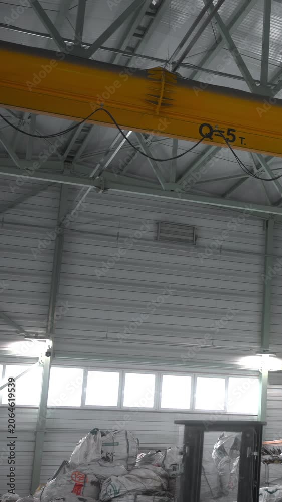 Industrial Setting Featuring Yellow Crane Spanning Steel Beams With ...